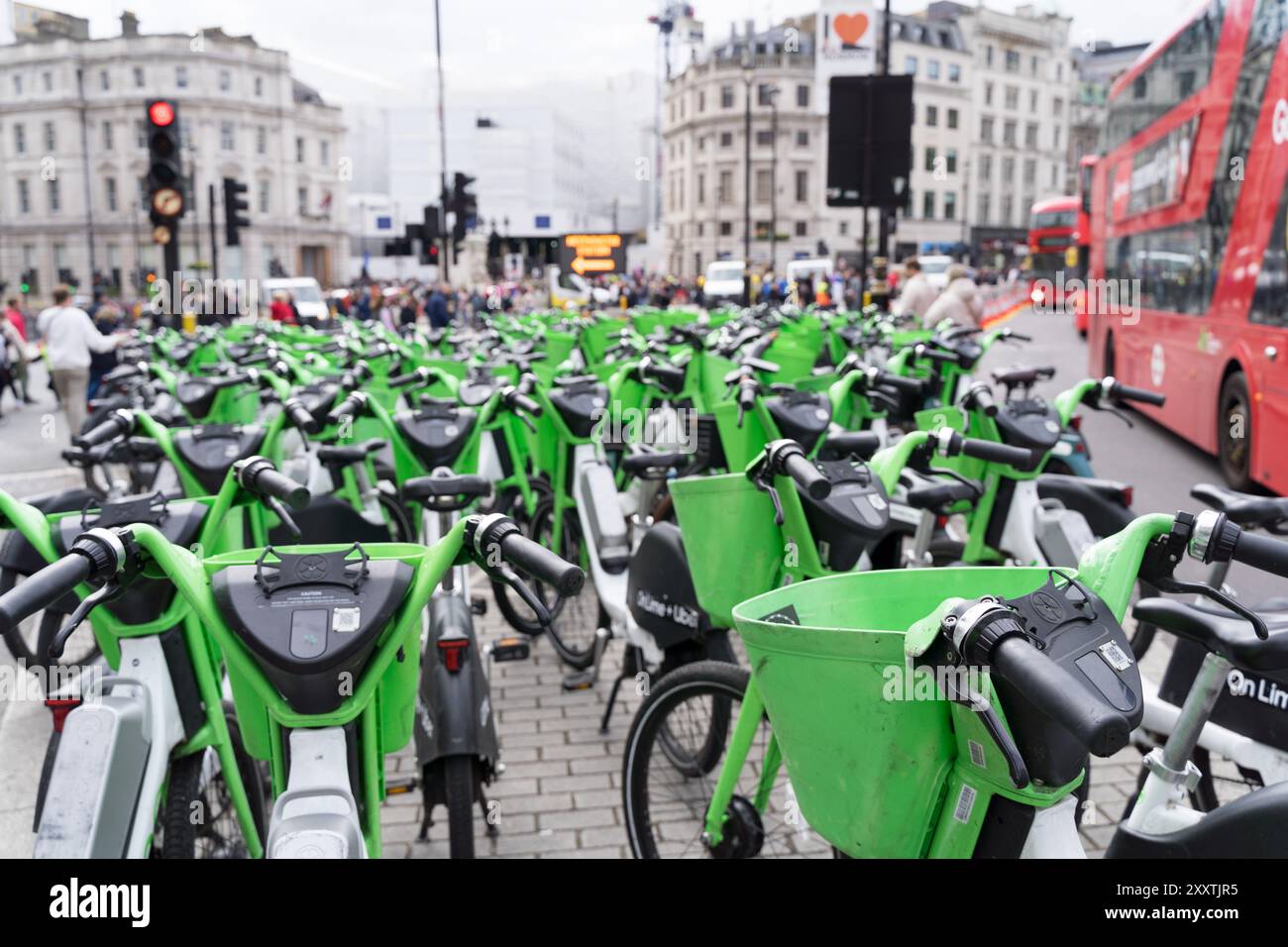 Masses of rental Lime e-bikes on pavement near Trafalgar square in West ...