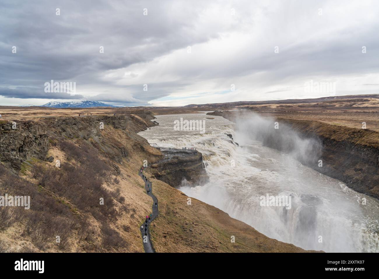 Water cascades over gullfoss waterfalls on a cloudy day in Iceland at ...