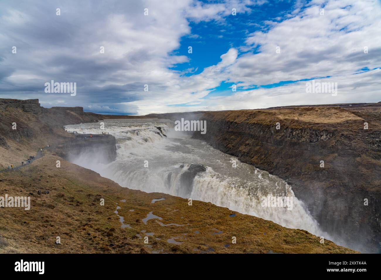 Water cascades over gullfoss waterfalls on a cloudy day in Iceland at ...