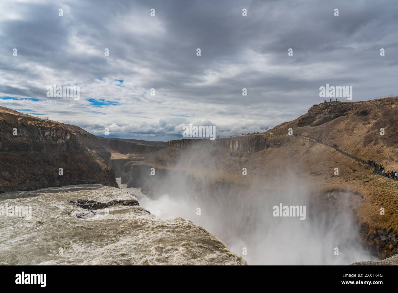 Water cascades over gullfoss waterfalls on a cloudy day in Iceland at ...