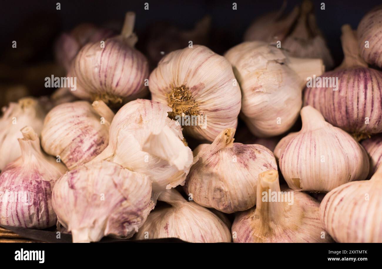 Heads of fragrant garlic in baskets on market counter Stock Photo - Alamy