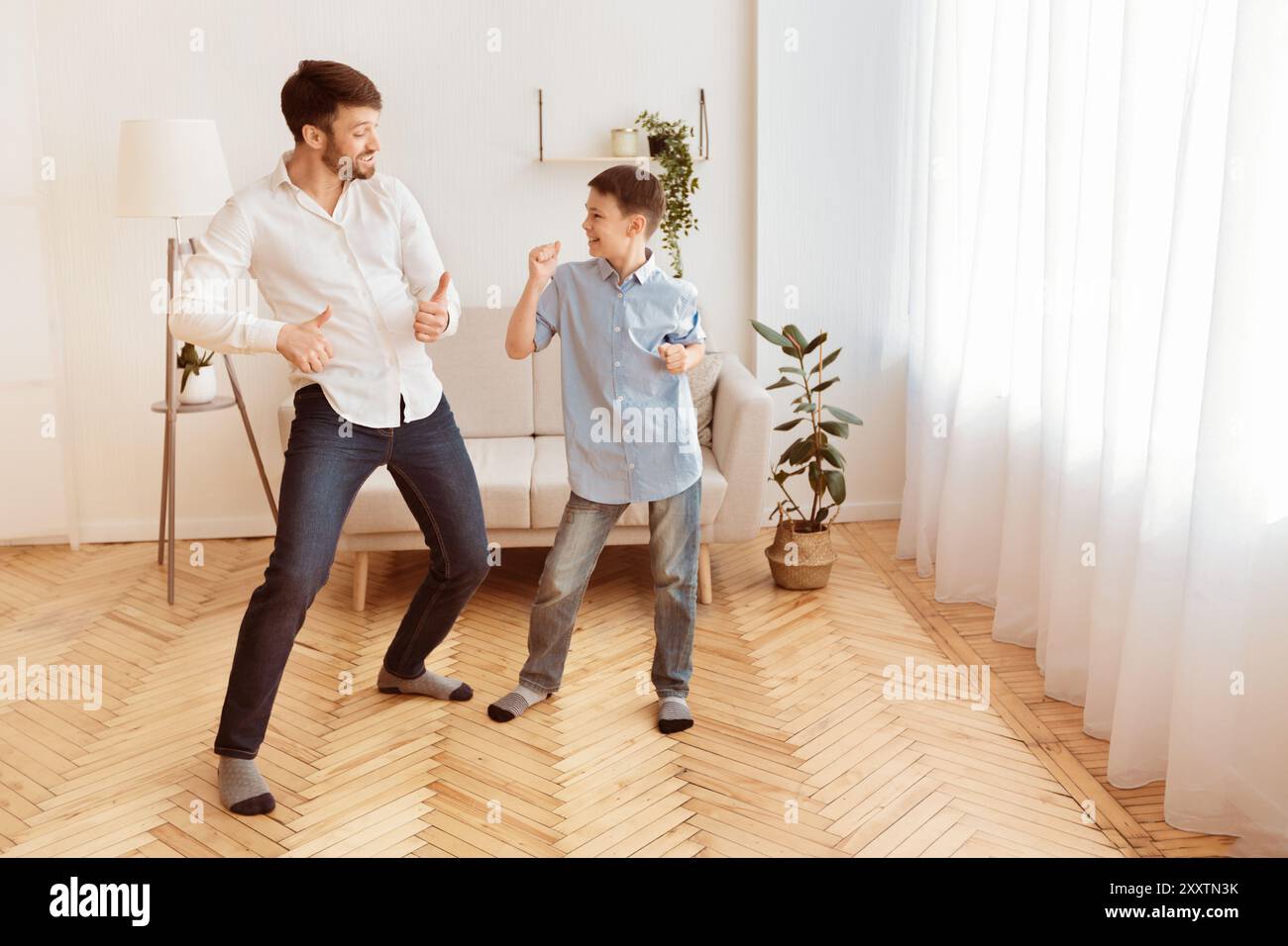 Father And Son Dancing Having Fun At Home On Weekend Stock Photo - Alamy