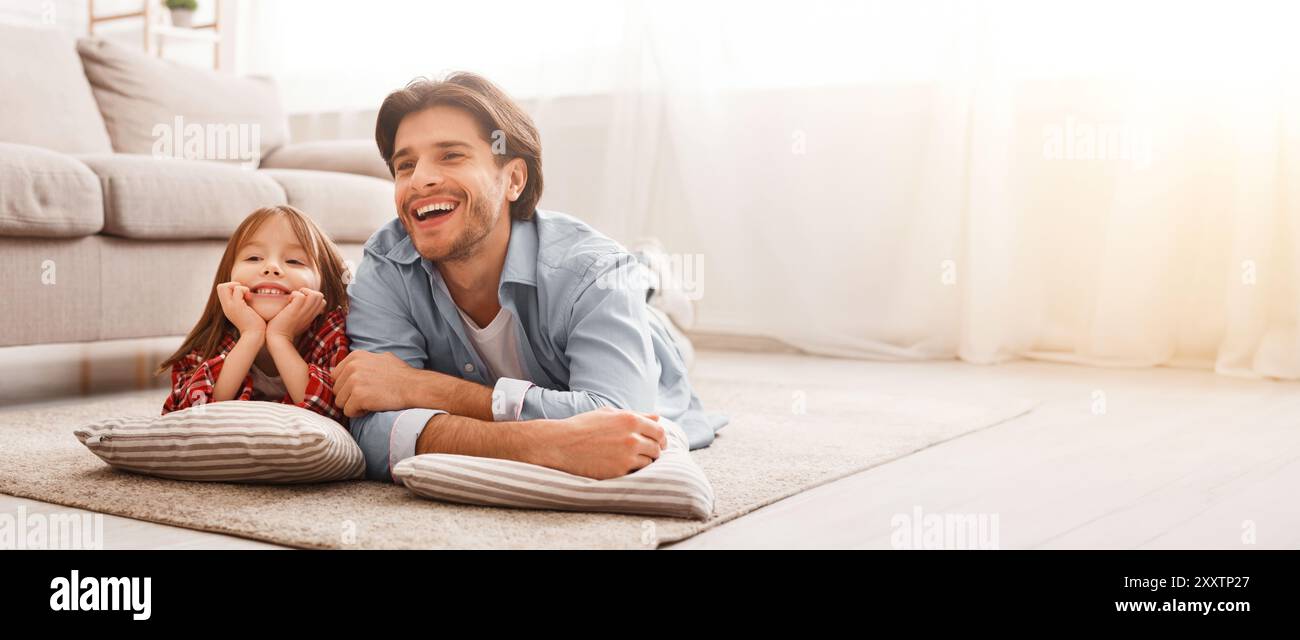 Happy family father and daughter watching TV on floor Stock Photo - Alamy