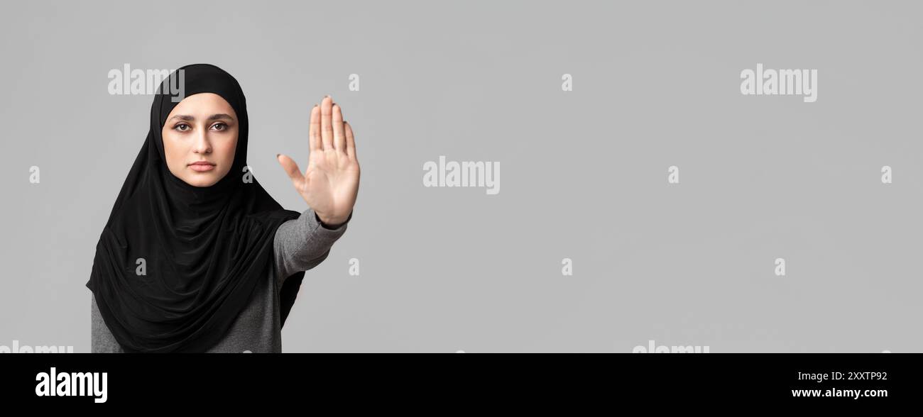 Muslim woman in hijab making stop gesture with her hand Stock Photo - Alamy