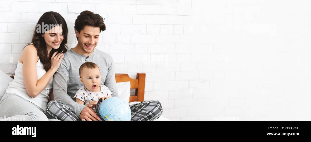 Family Togetherness: Parents Engaging With Their Curious Baby Stock ...