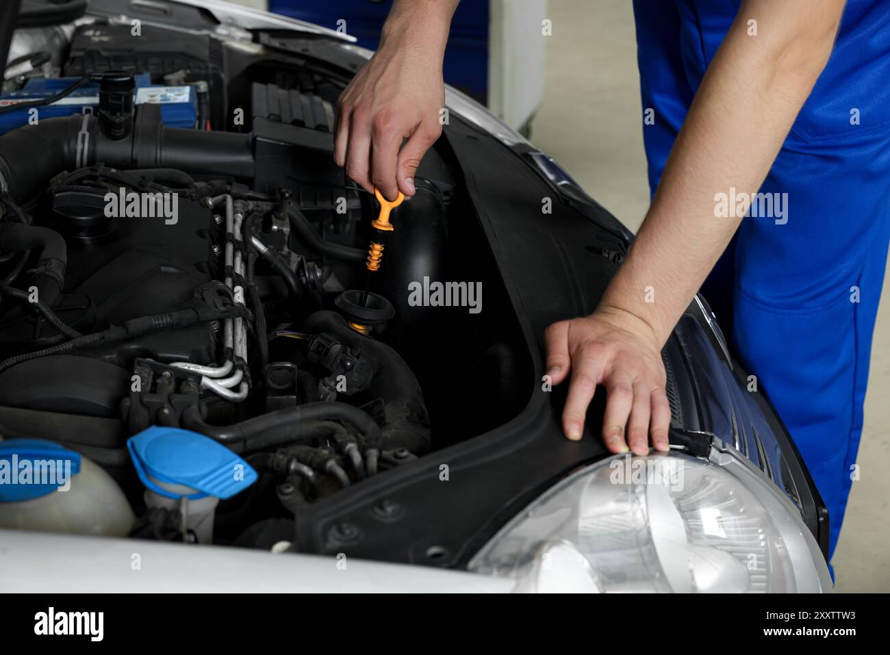 Auto mechanic fixing car at automobile repair shop, closeup Stock Photo ...