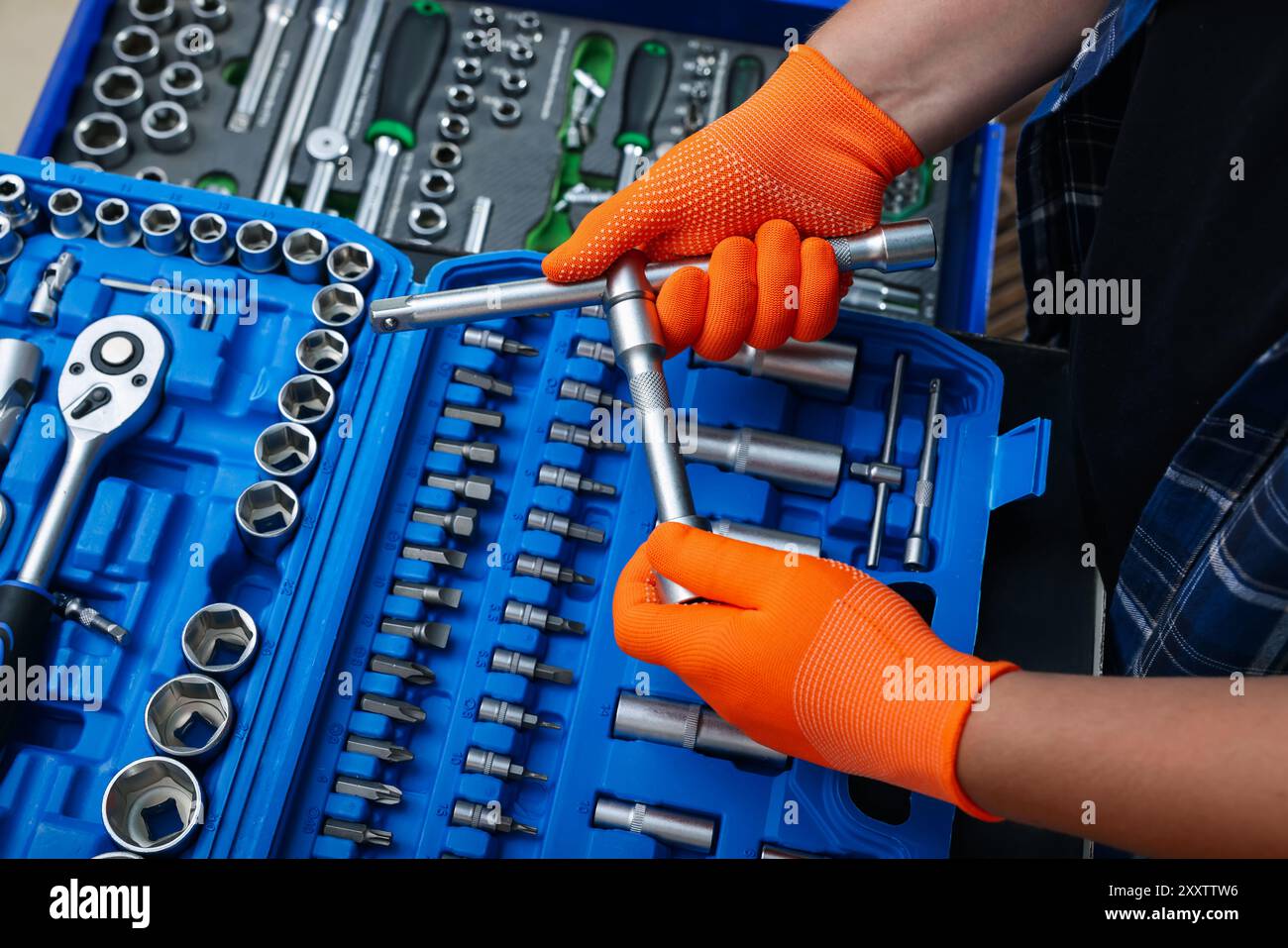 Auto mechanic with different tools at automobile repair shop, closeup ...