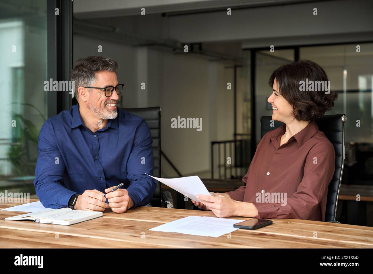 Two happy busy business executive leaders working together in office at ...
