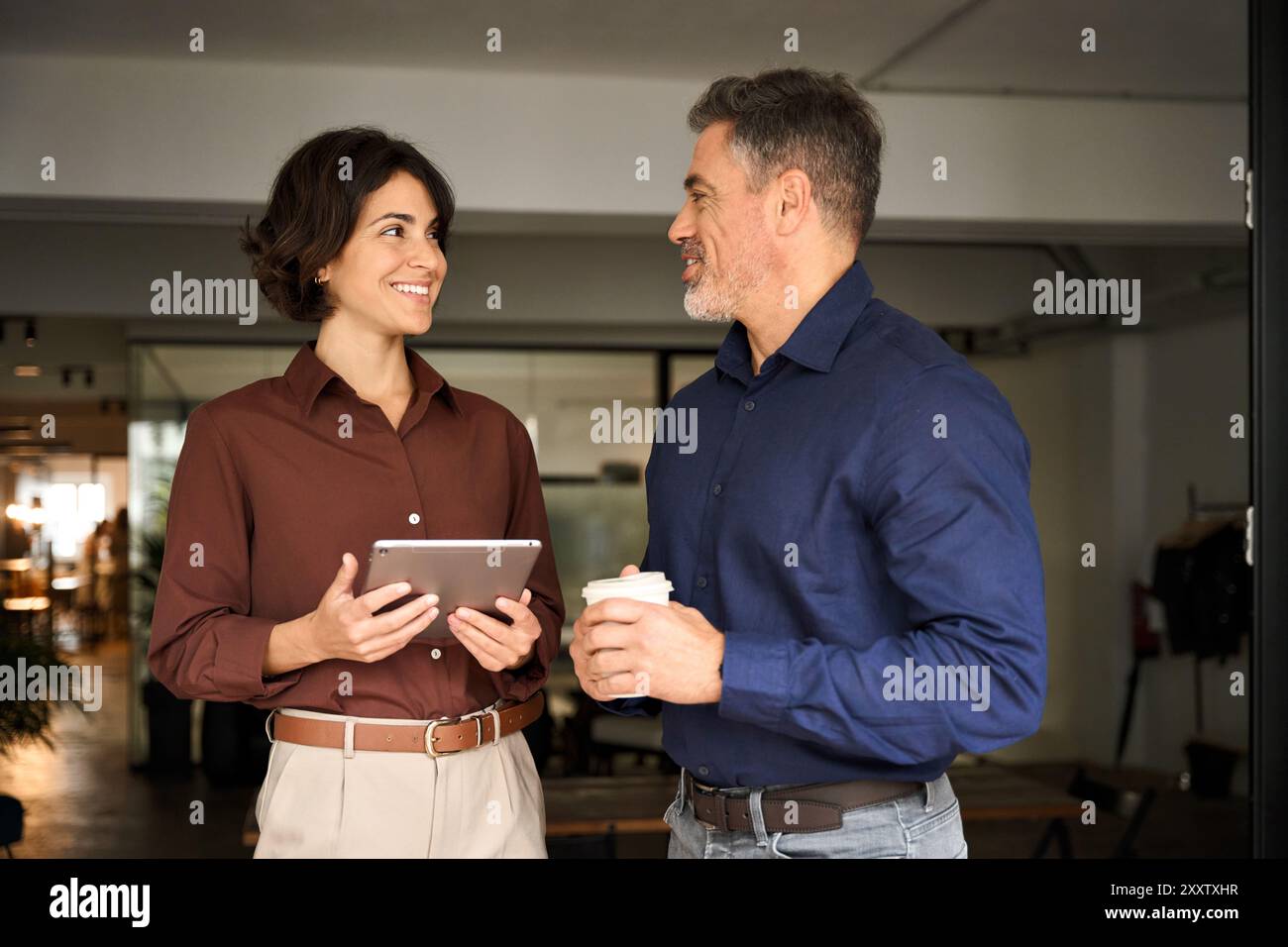 Happy executives team two business people working talking standing in ...