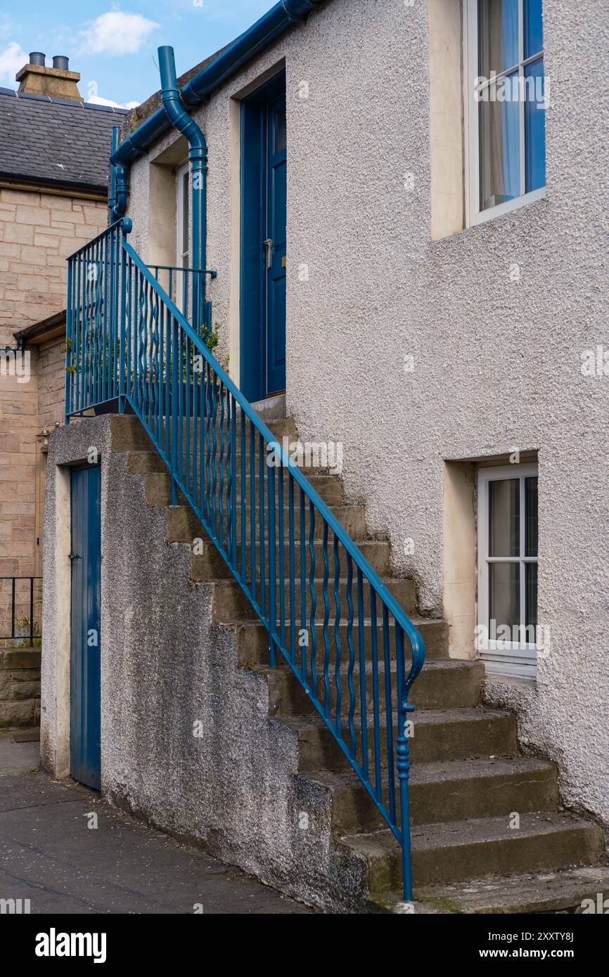 EDINBURGH - JULY 28, 2024: Quaint stone house features vibrant blue ...