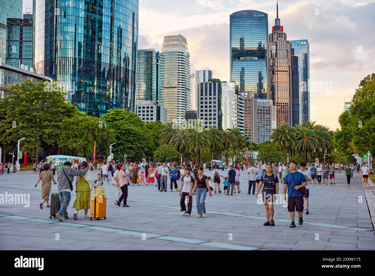 People walk in the Huacheng Square surrounded by modern high-rise ...