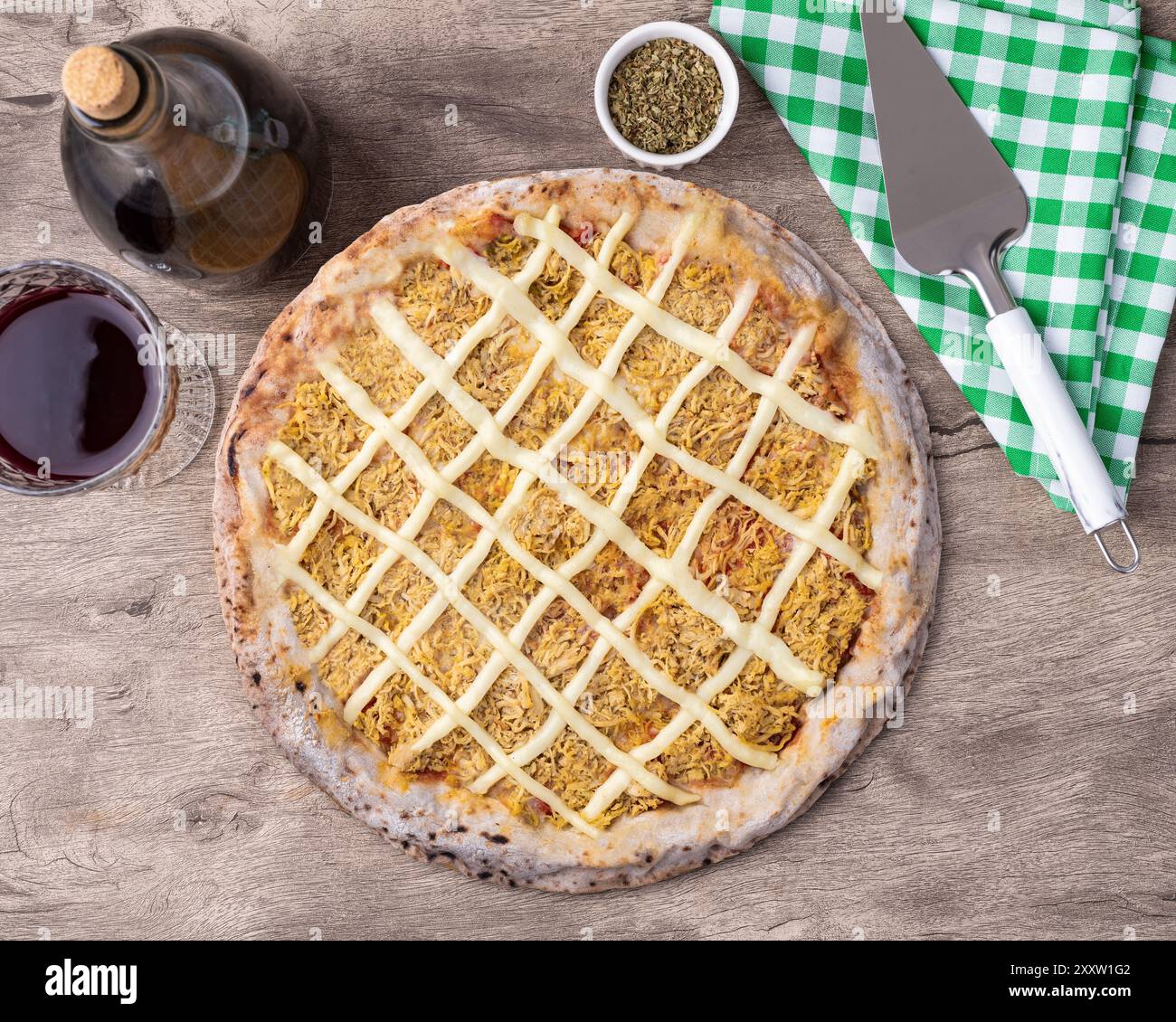 Chicken and Catupiry cream cheese pizza over wooden table with wine ...
