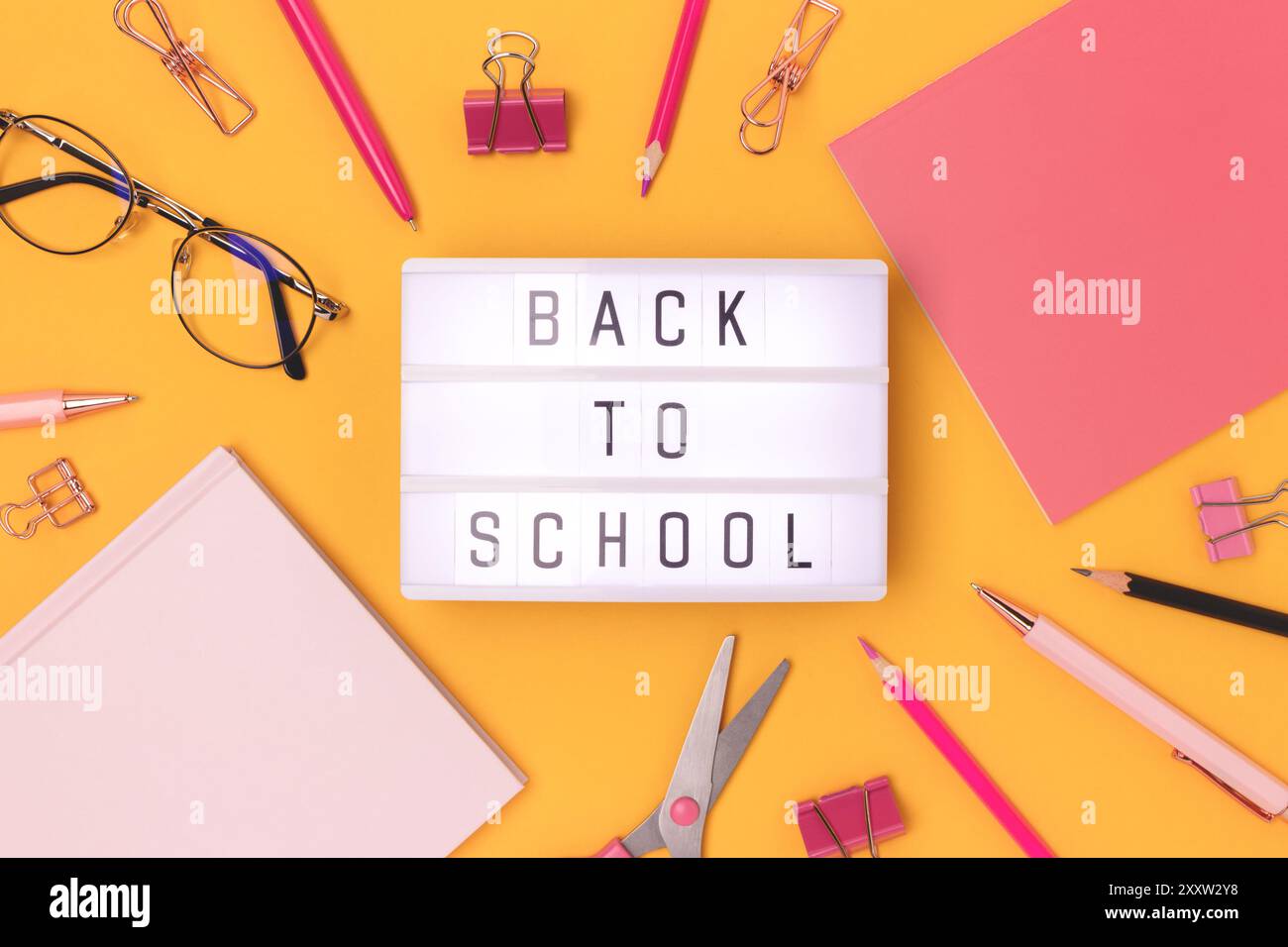 Back to school. Lightbox with letters and frame made of pink colored ...