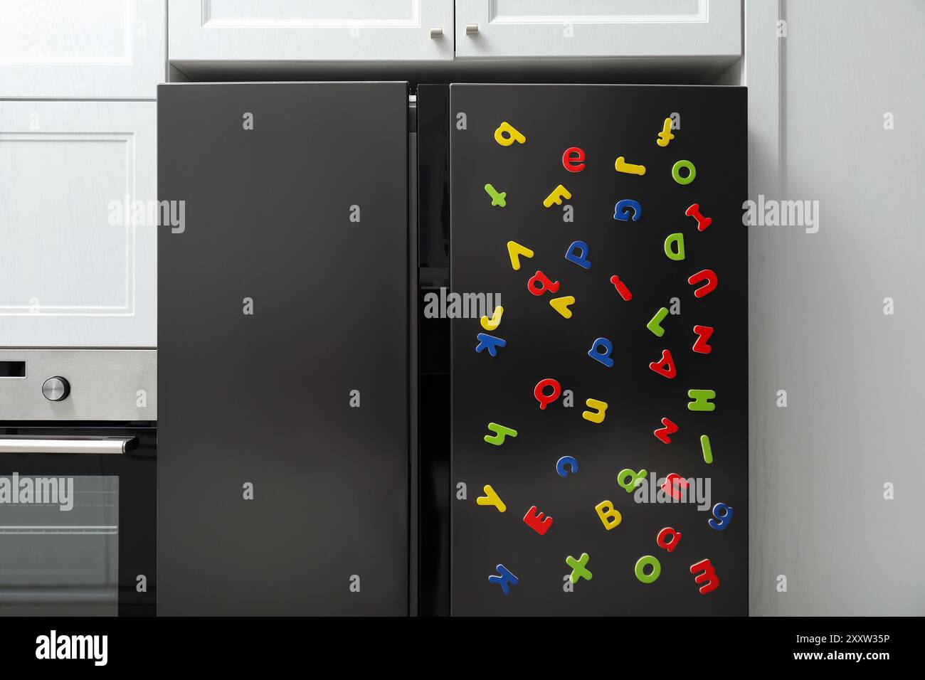 Many bright magnetic letters on fridge indoors. Learning alphabet Stock ...