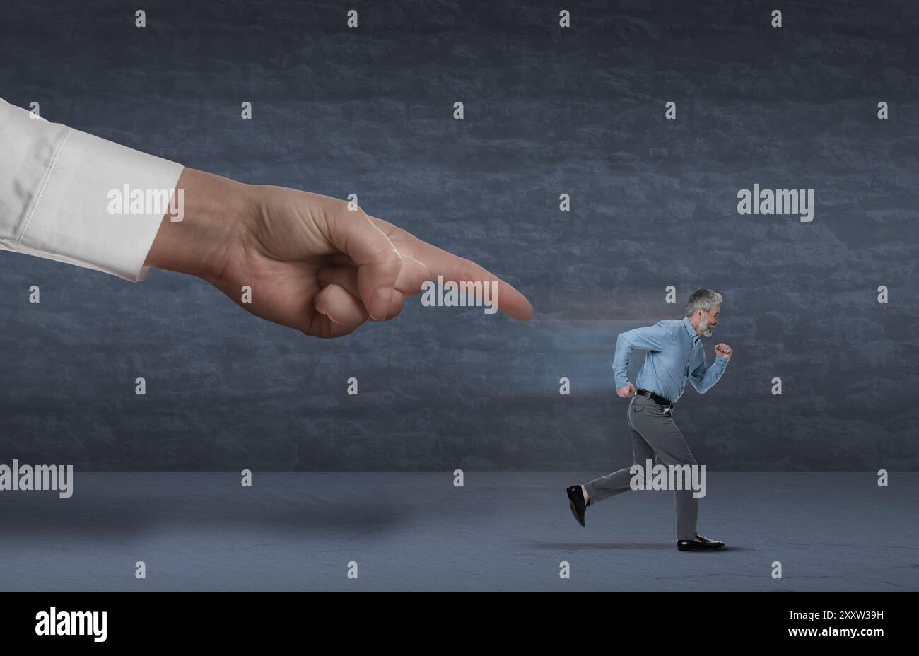 Big hand pointing at running away small businessman on grey background ...