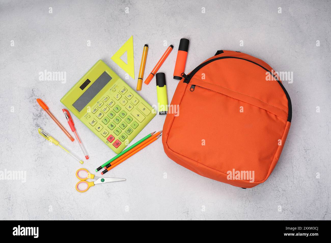 Flat lay composition with backpack and different school stationery on light grey table Stock ...