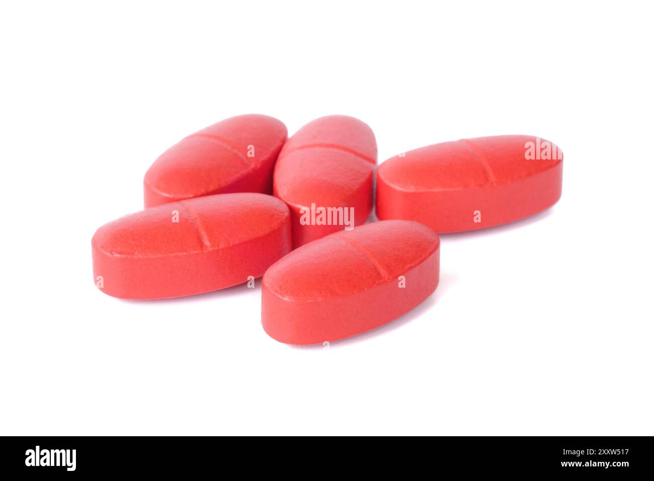 Red oral medication tablets close up on white background Stock Photo ...