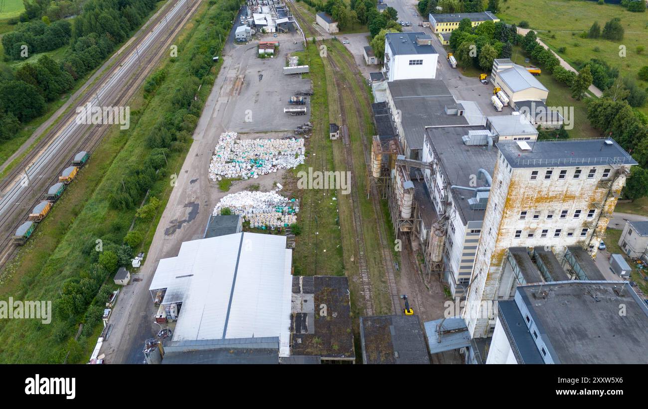 Drone photography of grain silo and factory near a railroad during ...