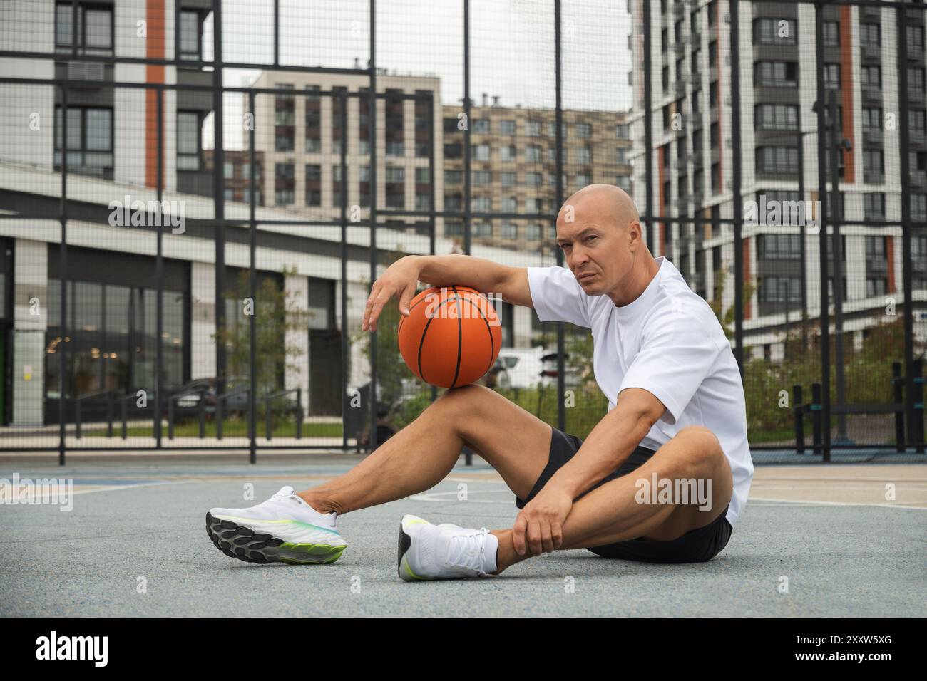 Portrait man sitting on basketball hi-res stock photography and images ...