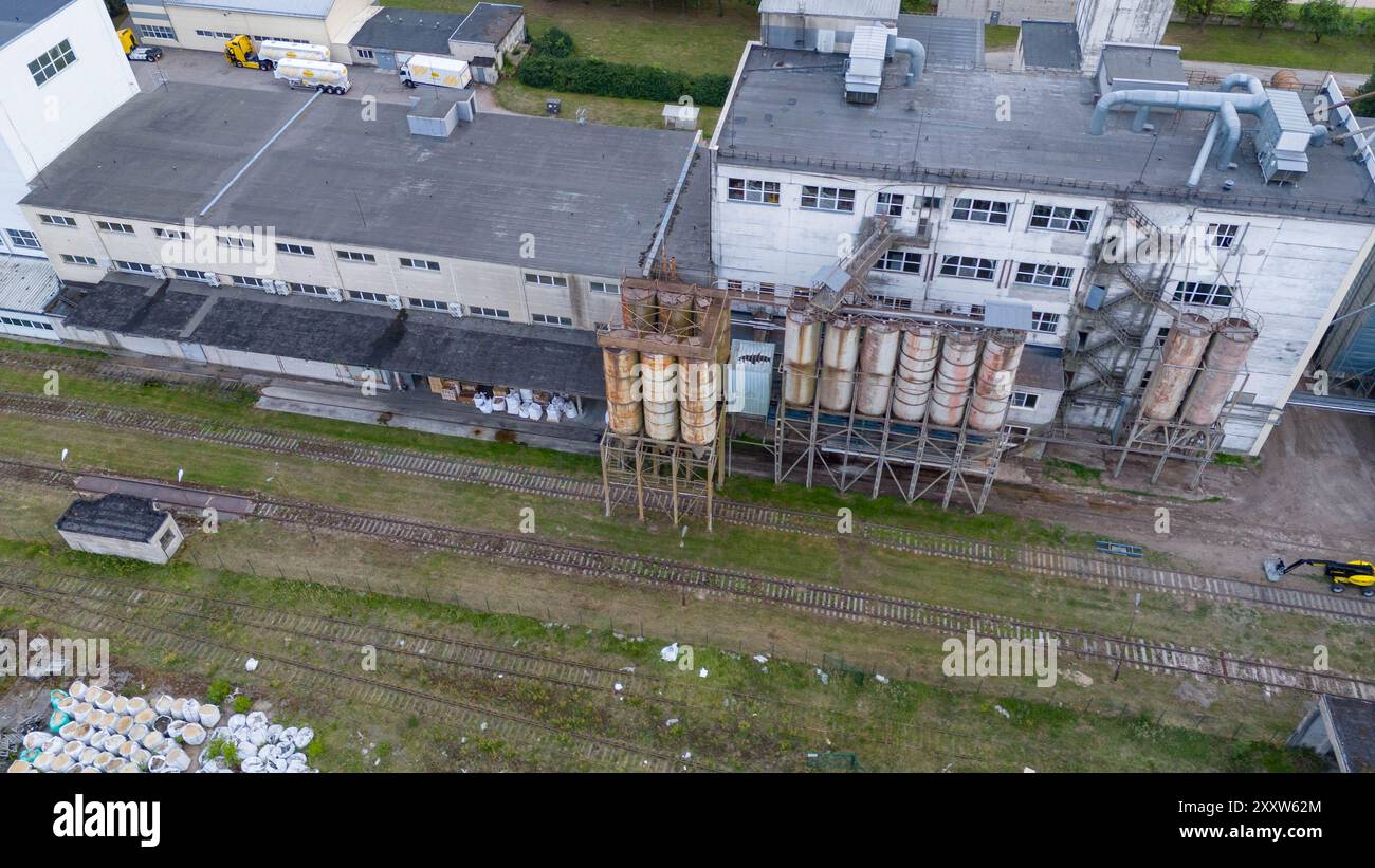 Drone photography of grain silo and factory near a railroad during ...