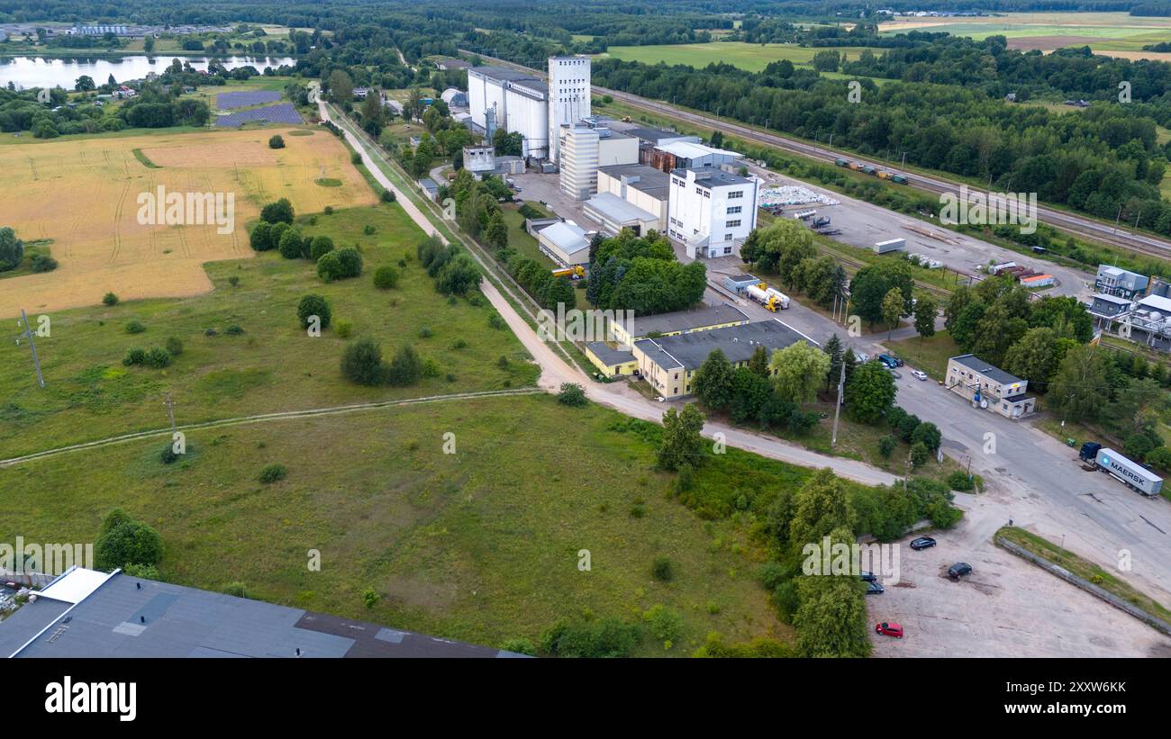 Drone photography of grain silo and factory near a railroad during ...