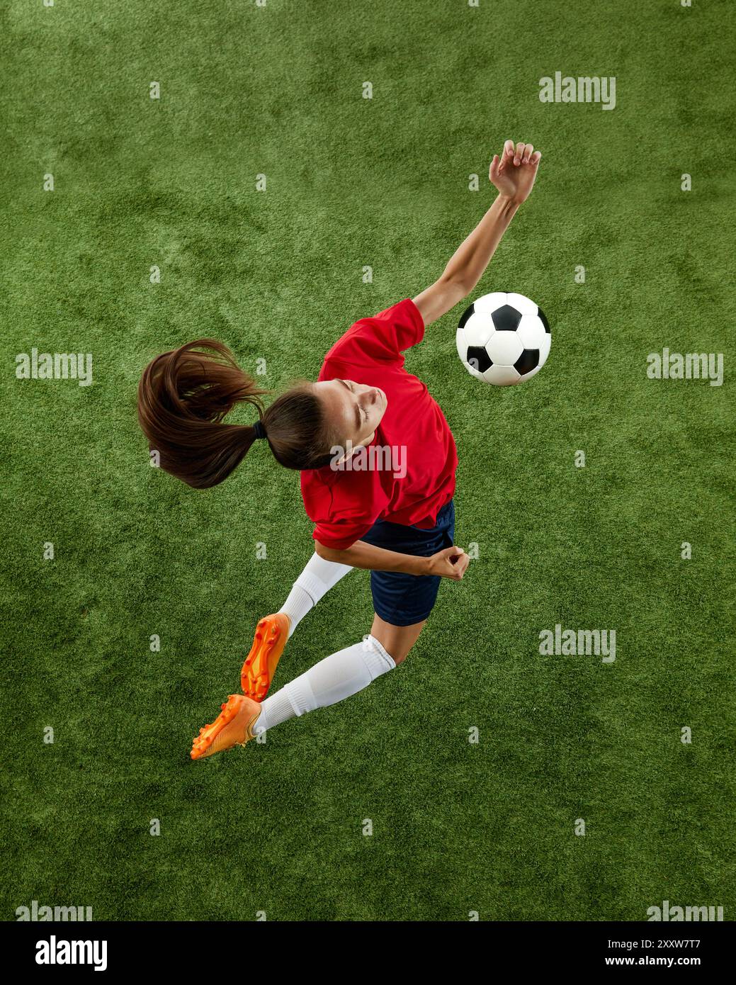 Aerial view of young athletic woman, football defender wearing ...