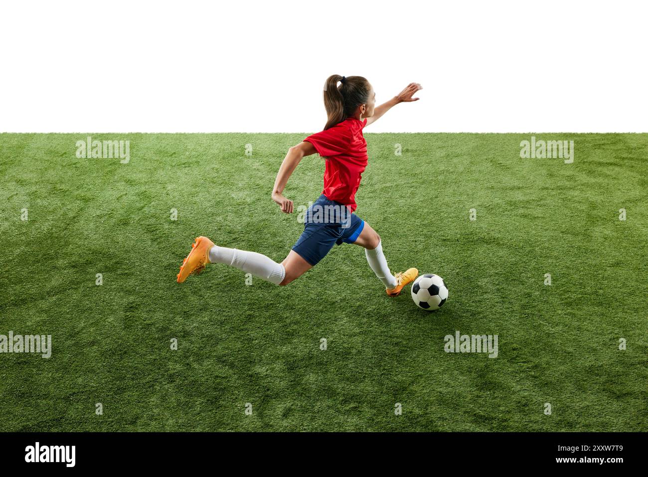 Competitive young woman, soccer player running across football field ...