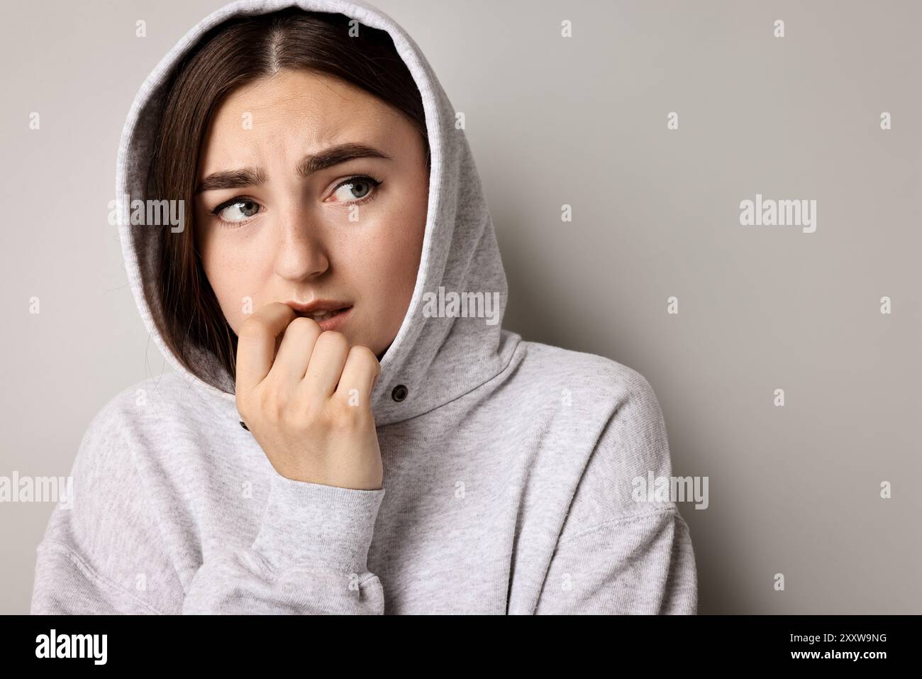 Portrait of scared woman on light background Stock Photo - Alamy