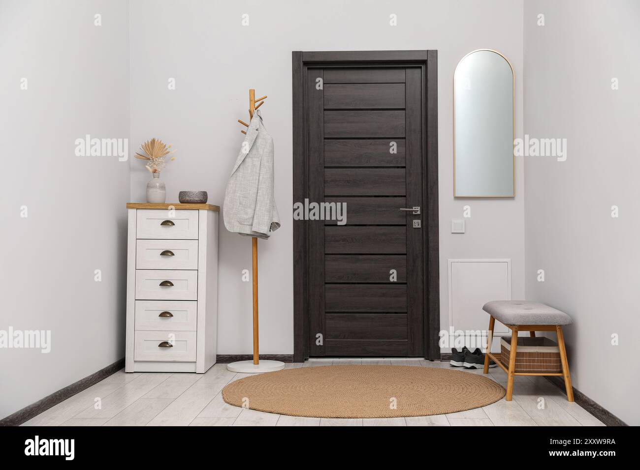 Coat rack, cabinet and shoe storage bench in hallway. Interior design ...
