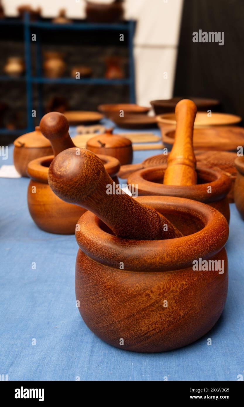 A table with a variety of wooden bowls and spoons. The bowls are of ...