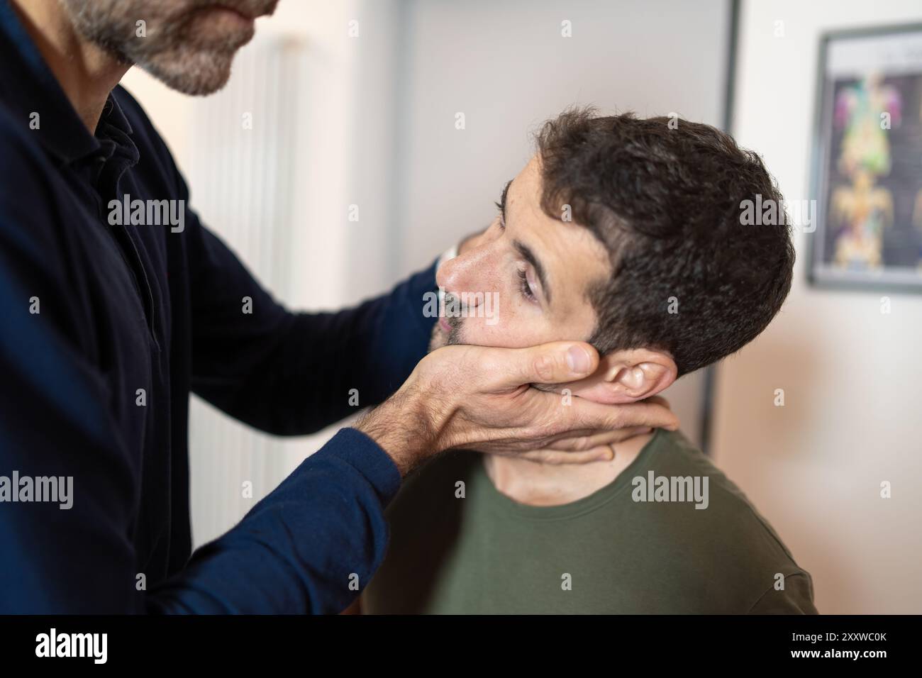 Close-up of an osteopath performing cervical manipulation and ...