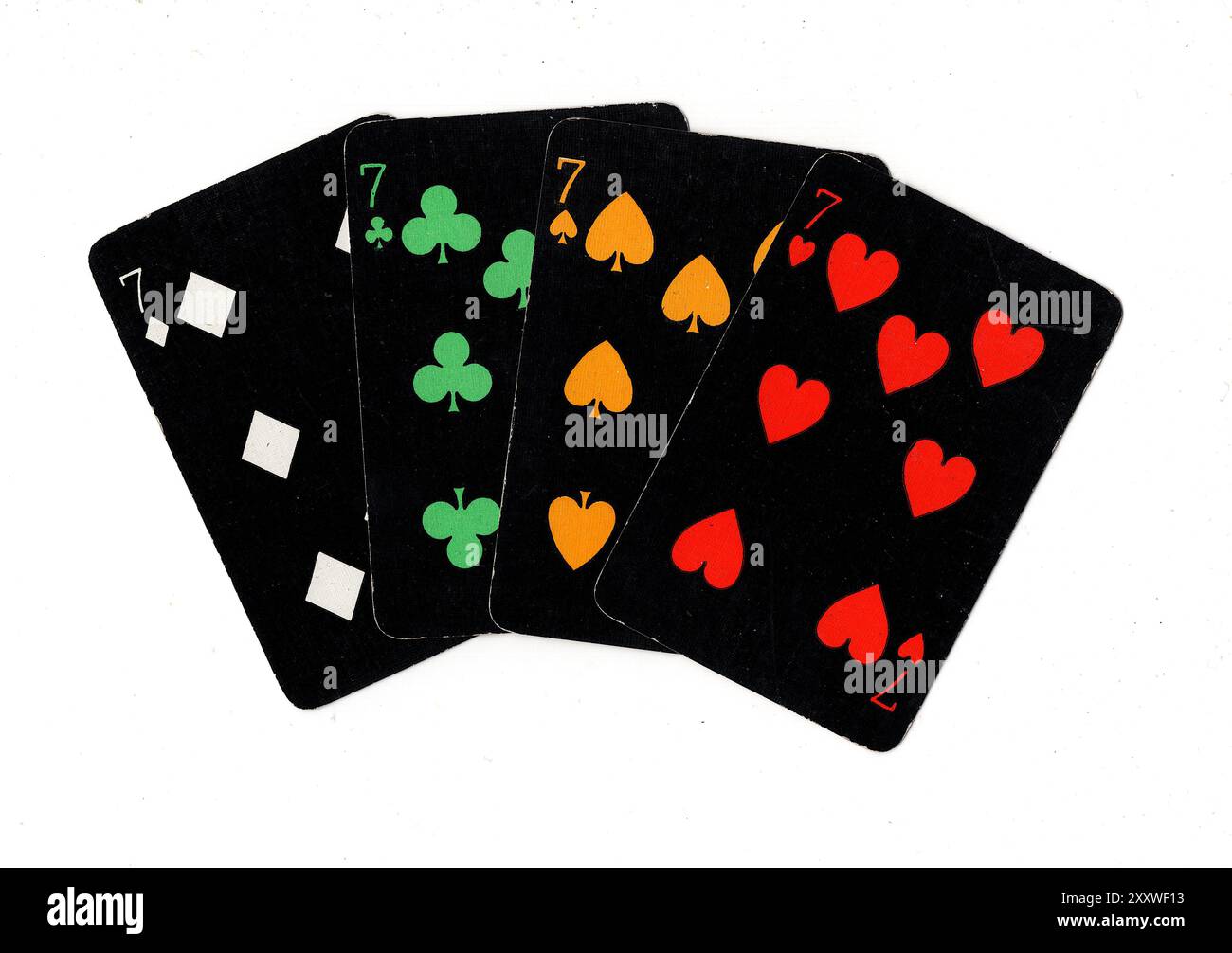 Vintage black playing cards showing four sevens on a white background ...