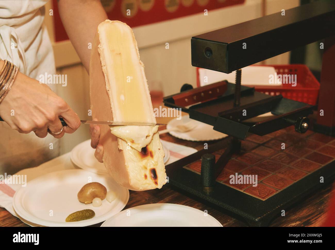 Old ancient way to cook raclette, traditional swiss cheese plate Stock ...