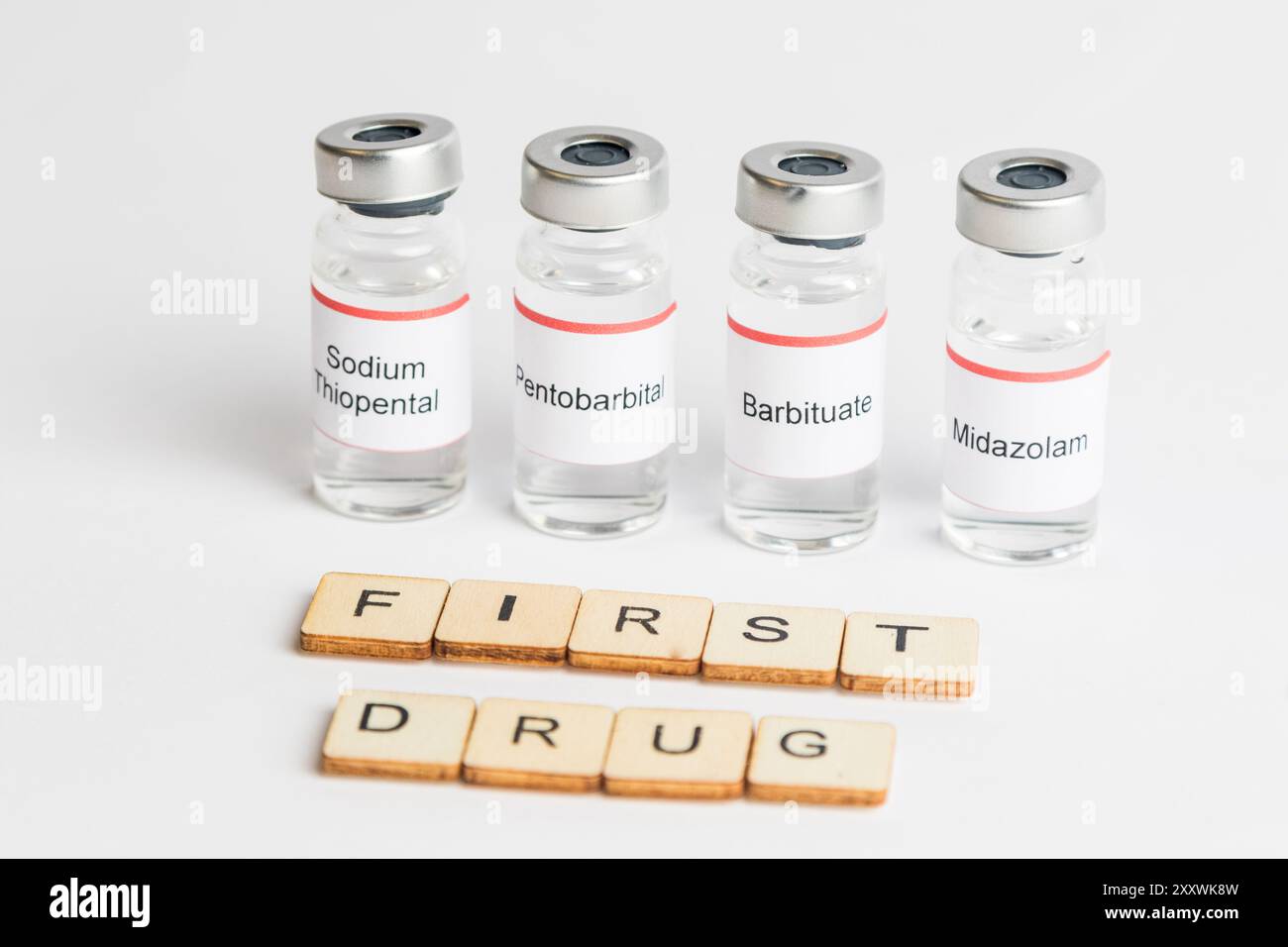 Medical Vials With A Label Reading The Names Of Lethal Injection Drugs With A Sign Reading First