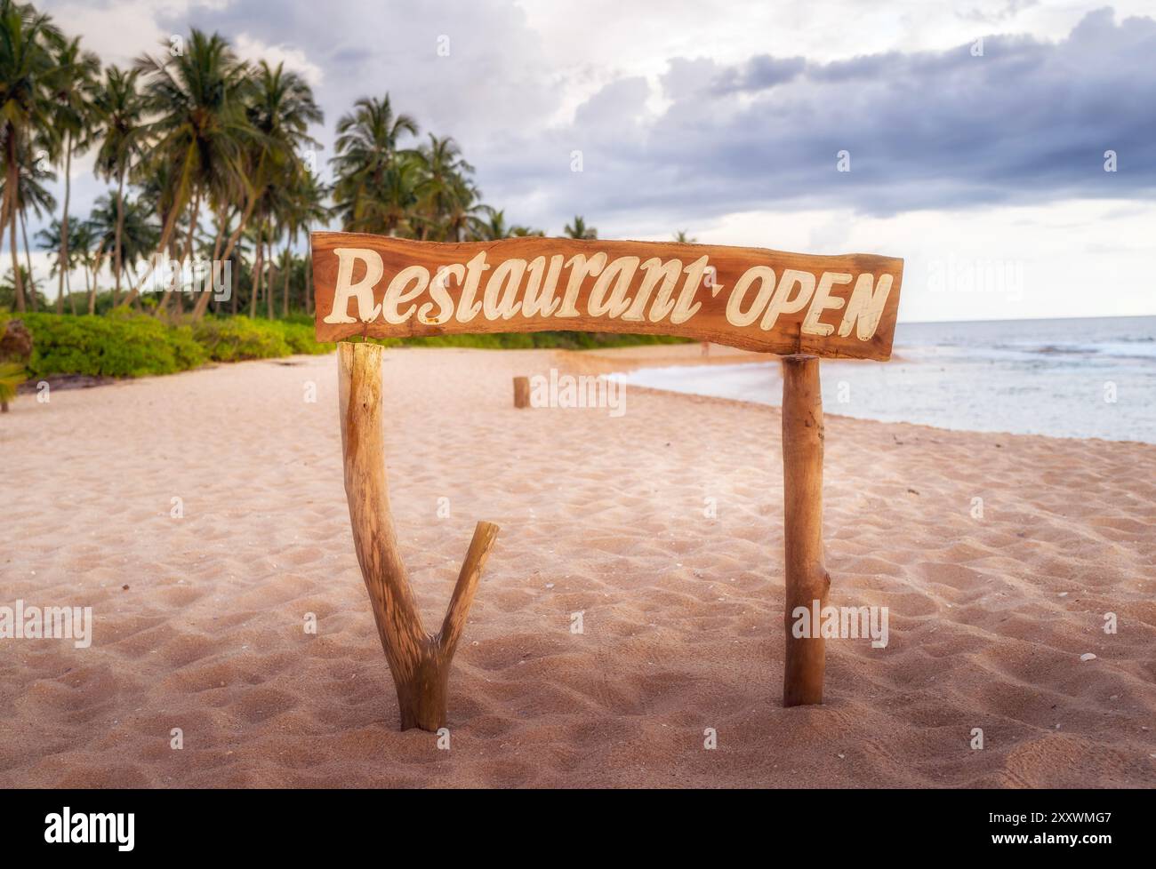 Tropical Beach restaurant sign indicating that it is open Stock Photo ...
