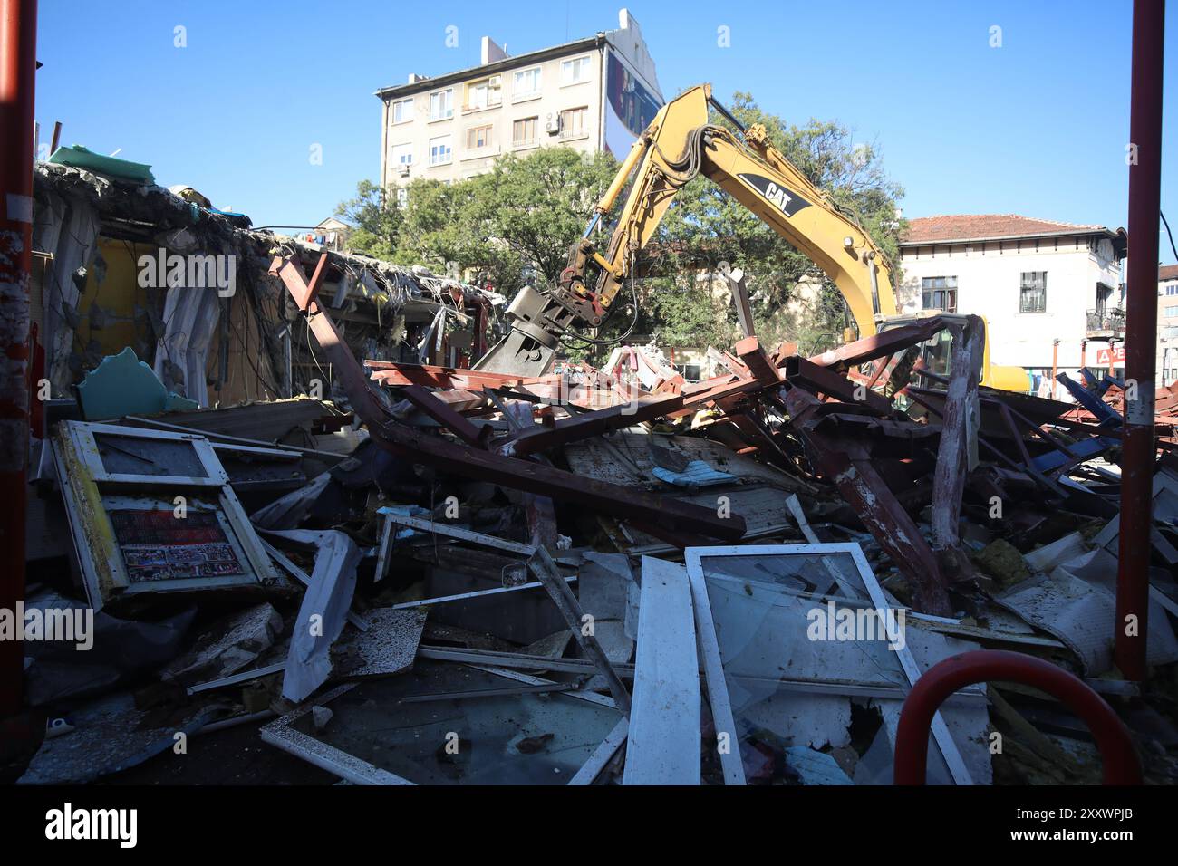 Demolition of buildings with a hydraulic excavator. Demolition of a ...