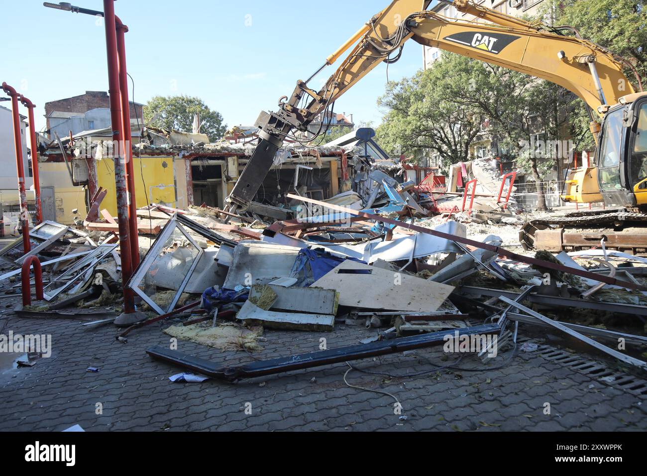 Demolition of buildings with a hydraulic excavator. Demolition of a ...