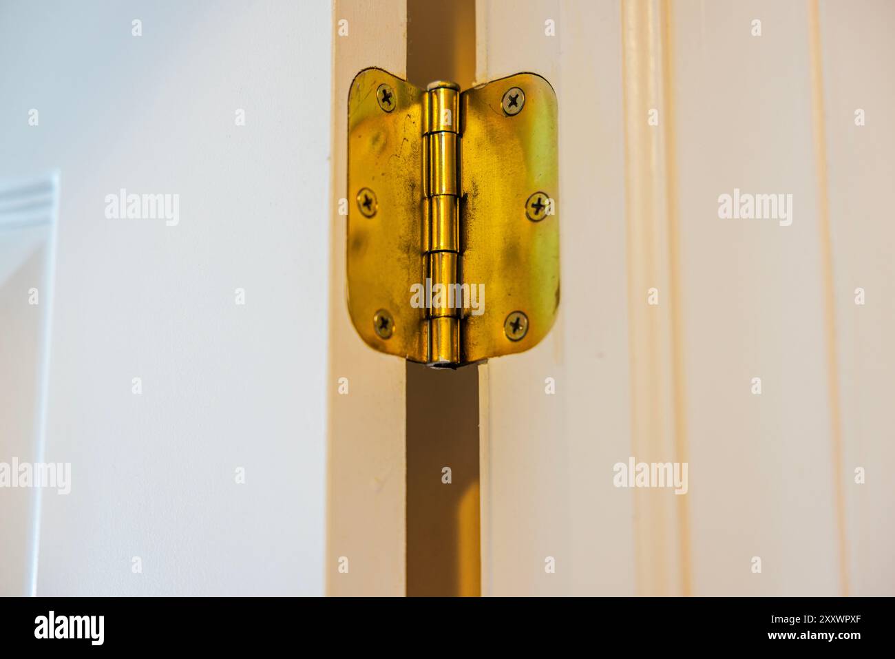 Close-up view of vintage-style golden hinge holding door. USA Stock ...