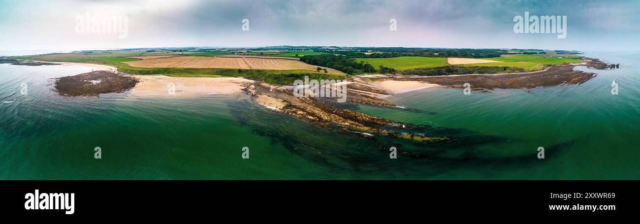 The drone captures an expansive view of Longhoughton Beach, featuring ...