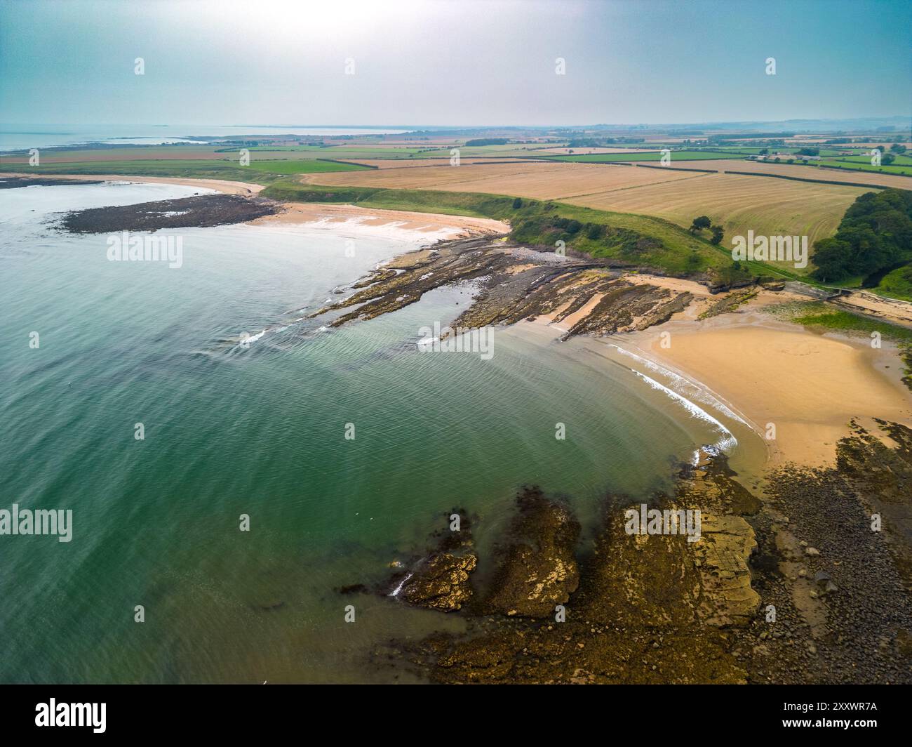 The drone captures an expansive view of Longhoughton Beach, featuring ...