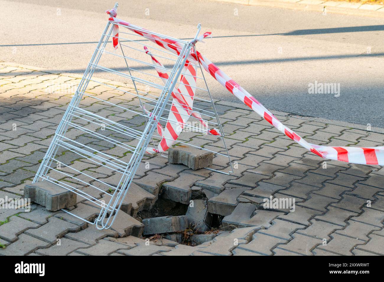 Fenced area. Road surface repair. Pothole in the sidewalk Stock Photo ...
