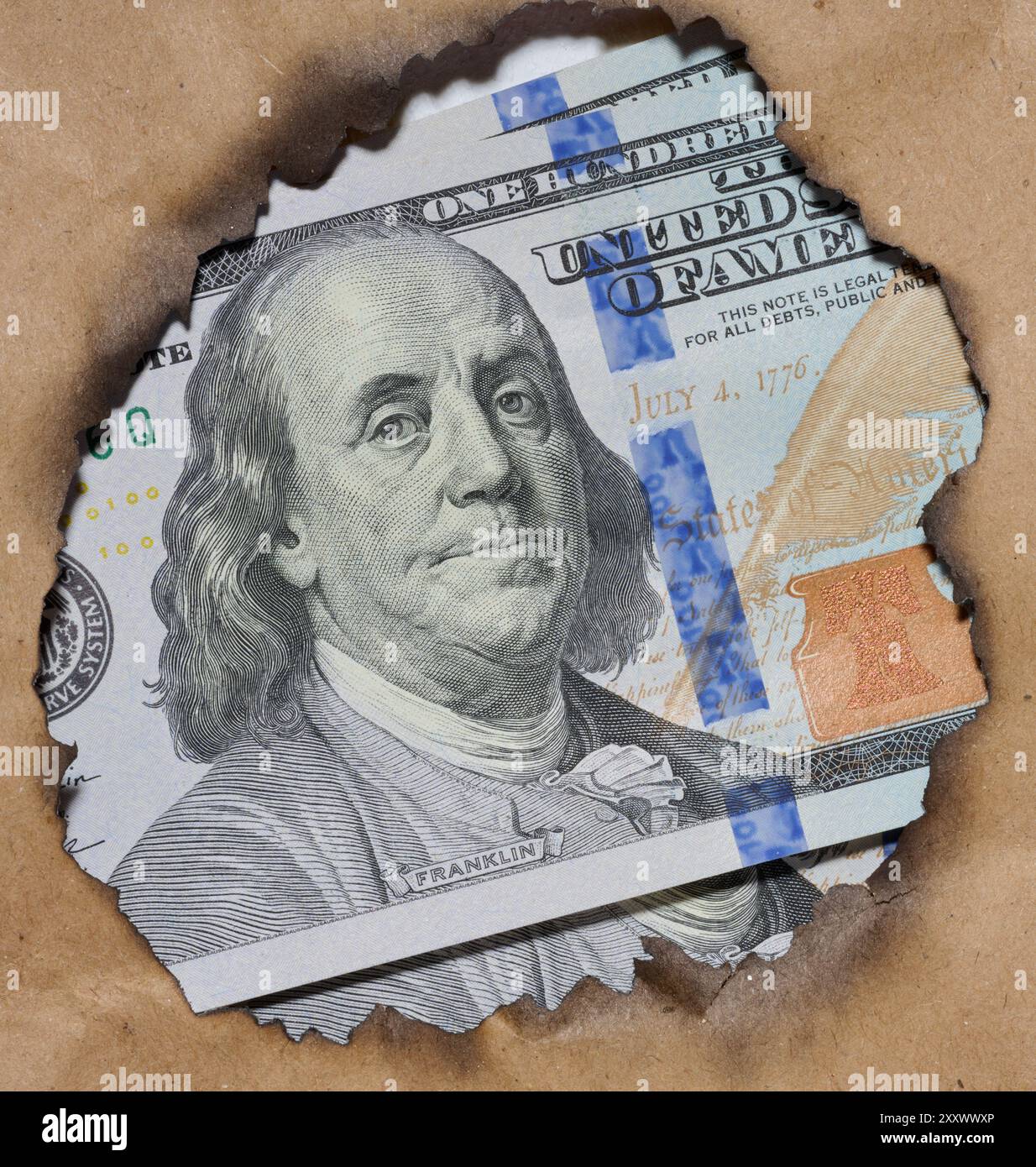 A portion of a US $100 bill featuring Benjamin Franklin, the bill ...