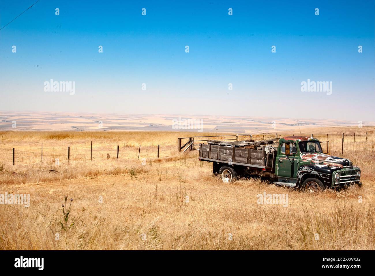 An iconic truck stands abandoned against the picturesque backdrop of Pendleton, Oregon, with its ...