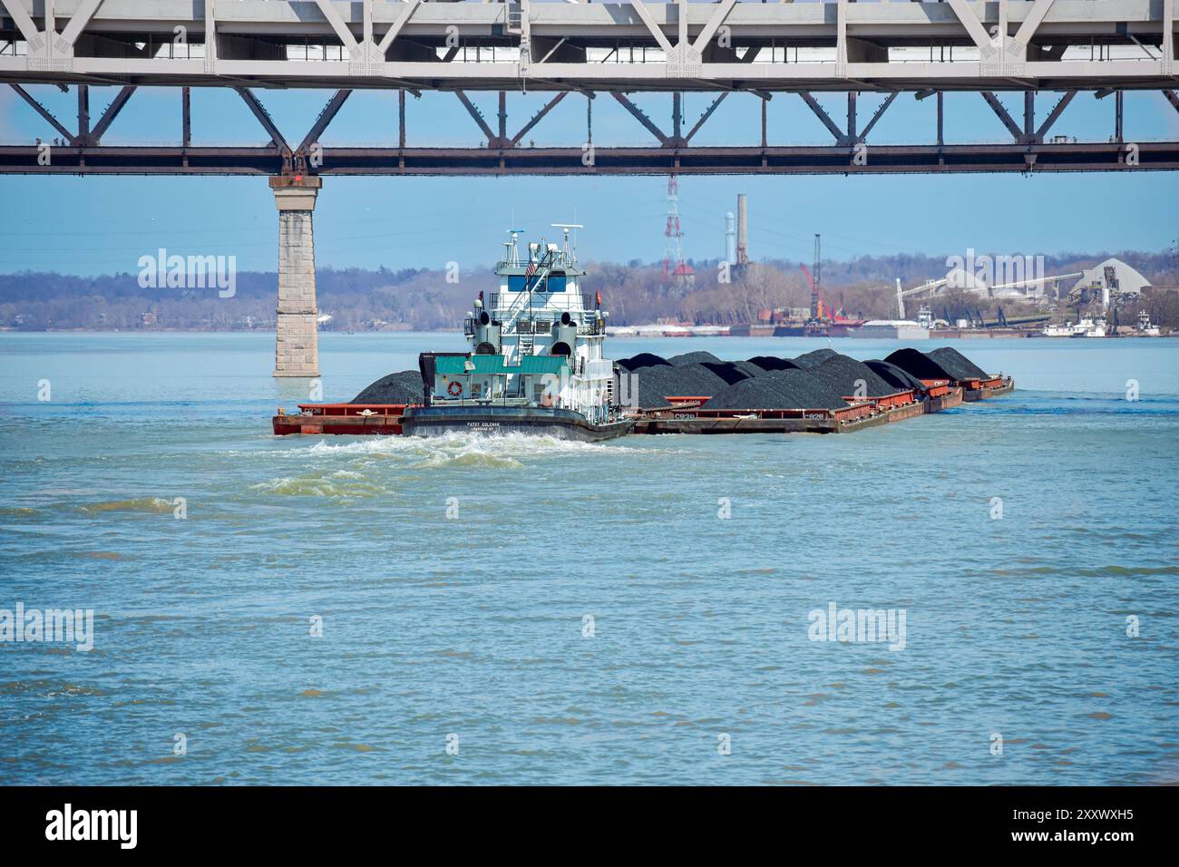 Coal barge moving up river under bridge Stock Photo - Alamy