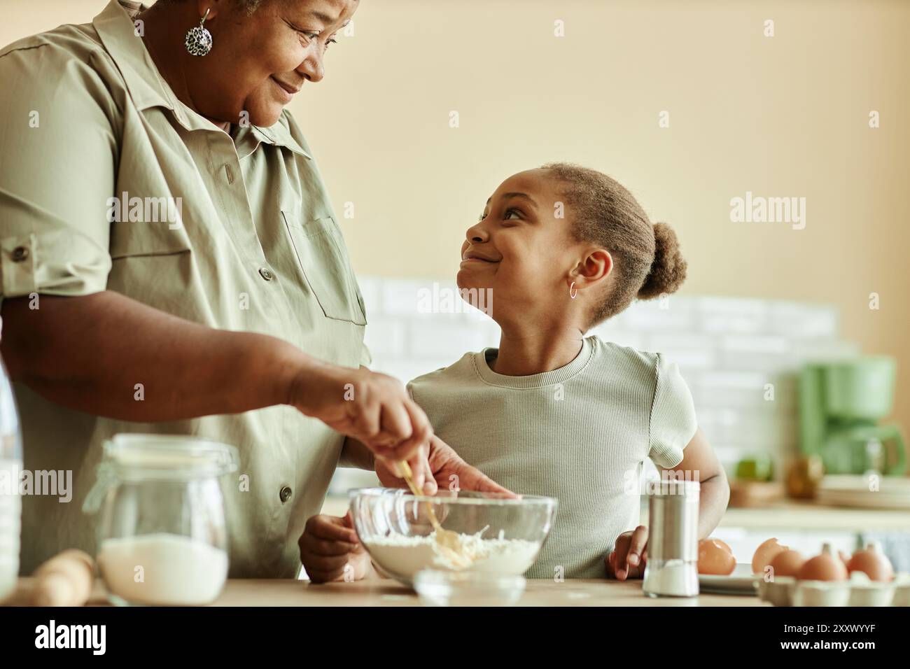 Side view of charming Black girl looking at loving grandma with adoring ...