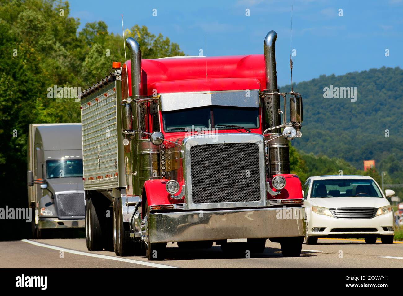 Horizontal shot of a heavy red dump truck on summertime Tennessee ...
