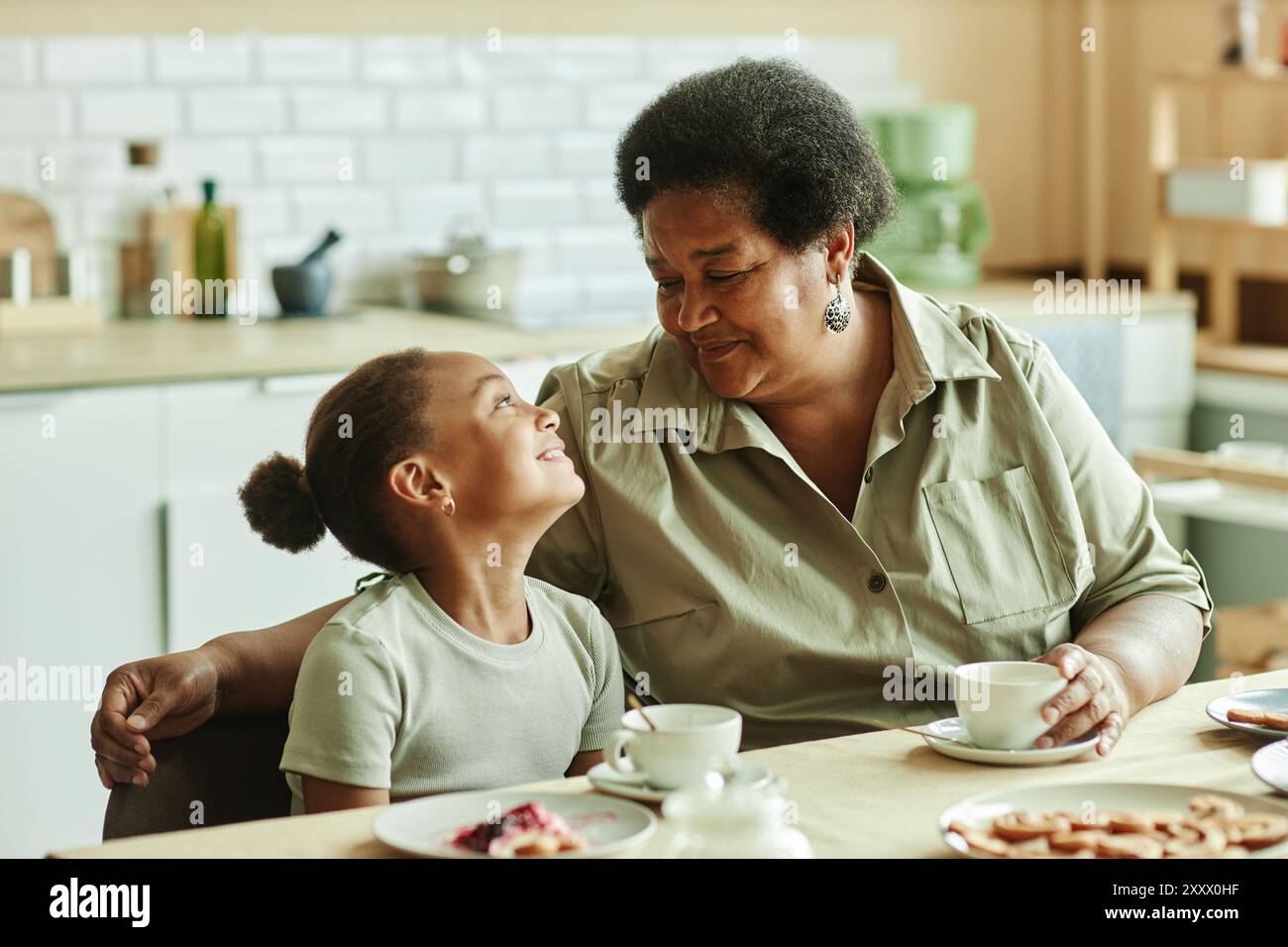 Medium shot of doting grandma looking with love and affection at ...