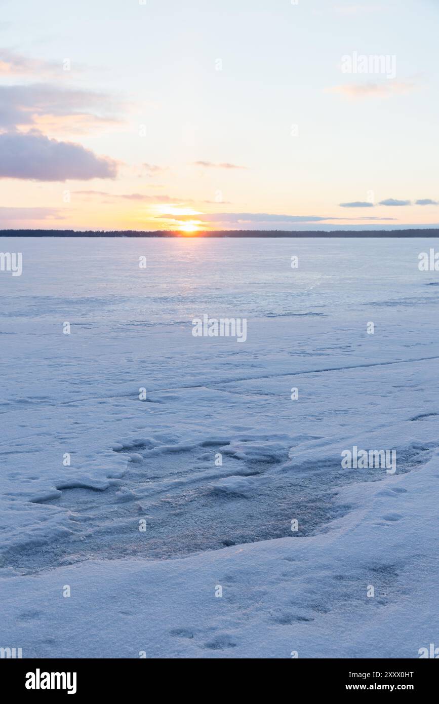 Winter landscape with frozen Baltic sea at sunset. Natural vertical ...