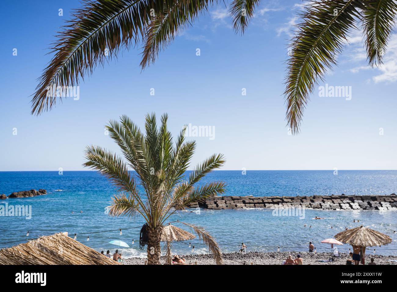 People enjoying the late afternoon sunshine in Ponta do Sol, Madeira on ...