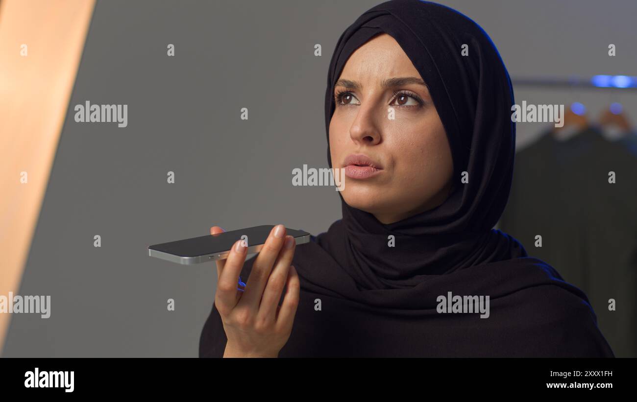 Angry displeased Islamic Muslim Arabian woman model lady speaking talk loudspeaker negotiate ...